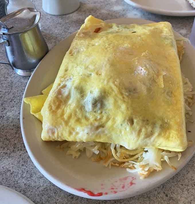 A bacon omelet that understands assignment, delivering crispy satisfaction with every golden, fluffy fold of egg perfection.