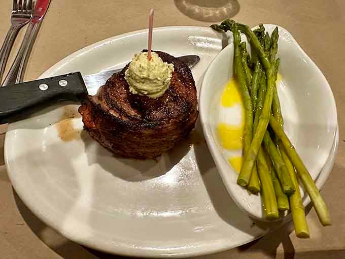 That perfectly seared filet with herb butter proves small-town restaurants can absolutely compete with big-city steakhouses.