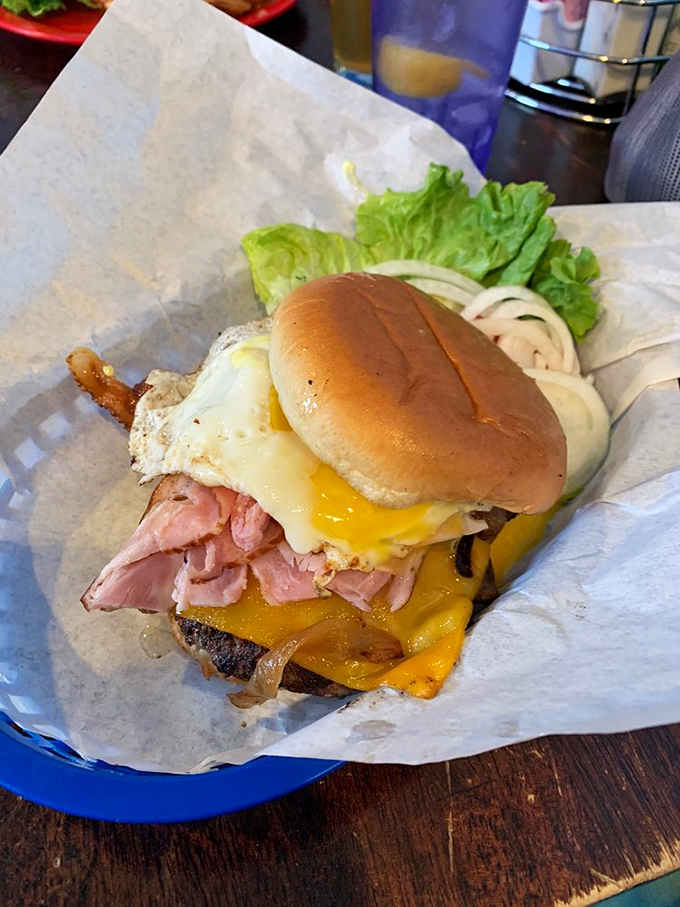 The Portlander arrives stacked higher than your expectations, proving that ham, egg, and bacon can absolutely coexist peacefully.