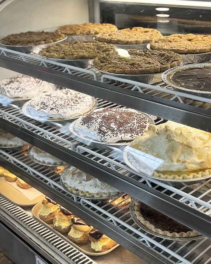 Rows of homemade pies cooling on racks like edible treasure waiting to make someone's day absolutely perfect.