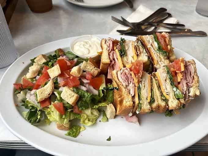 This towering club sandwich means business, stacked high with all the good stuff your cardiologist warned you about.