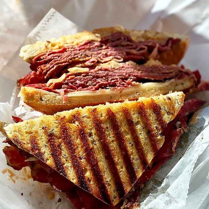 The Reuben arrives with those perfect grill marks that tell you someone back there actually cares about your lunch.