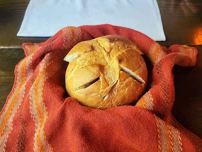 Warm bread wrapped in cloth like a delicious medieval baby—simple perfection that needs no introduction.