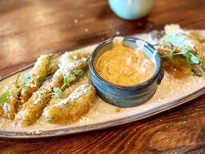 Tempura shishito peppers arrive golden and crispy, proving that vegetables can be exciting when properly introduced to hot oil.