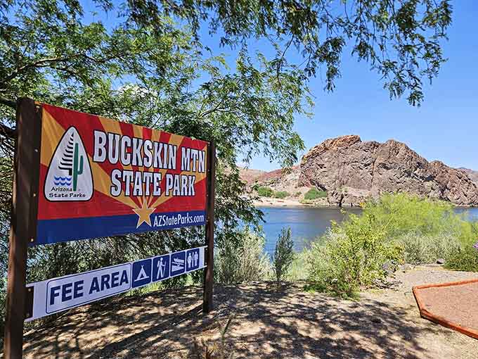 The colorful welcome sign promises adventure ahead, and judging by those mountains in the background, it's not bluffing about the views.