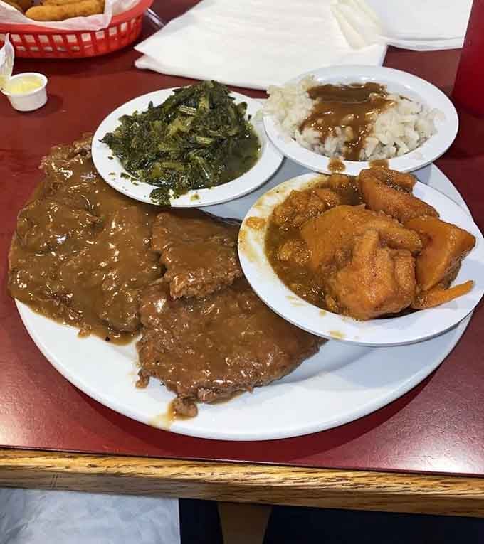 Country-style steak smothered in gravy with collards and fried chicken: because choosing one protein is for amateurs.