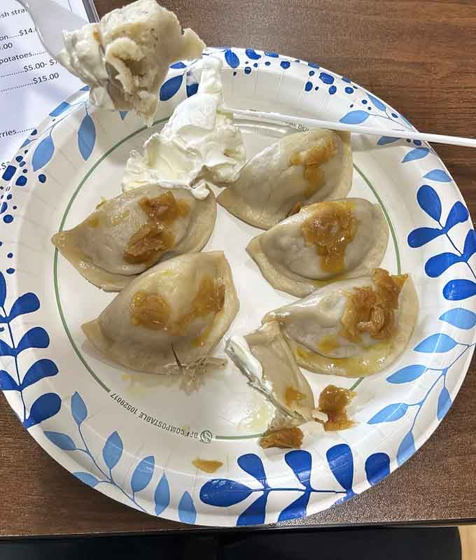Five perfect pierogis topped with caramelized onions and a dollop of sour cream: this is what happiness looks like.