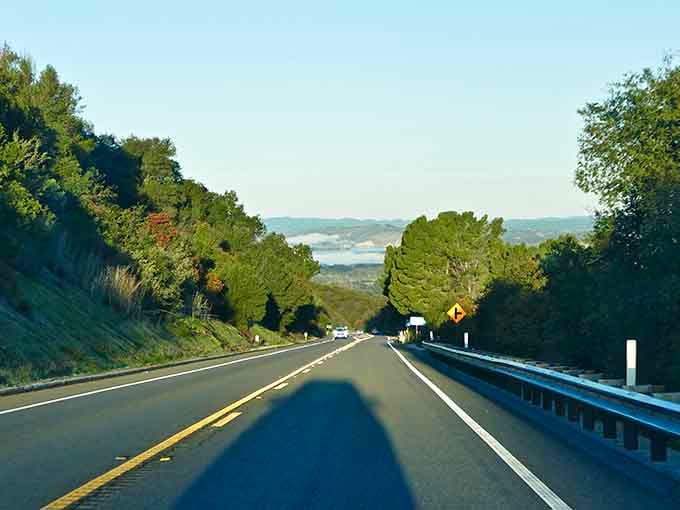 The open road ahead promises adventure while mountains frame the horizon like a postcard come to life.
