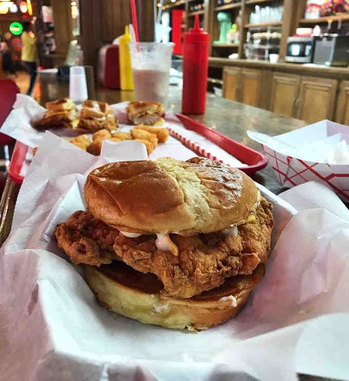 That breaded tenderloin is so gloriously oversized, it makes the bun look like it's having an identity crisis of confidence.