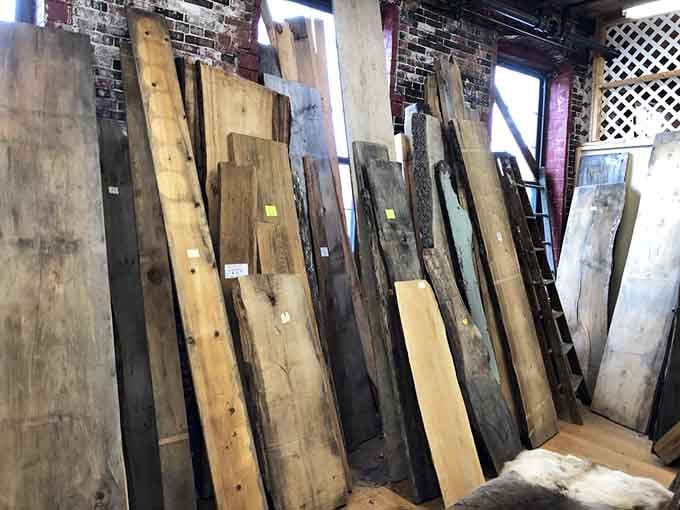 Reclaimed wood planks waiting to become someone's rustic masterpiece or very expensive cutting board.
