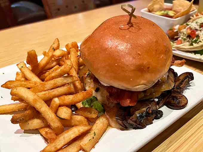 The Kahuna Burger towers like a delicious skyscraper, proving that sometimes bigger really is better when mushrooms are involved.