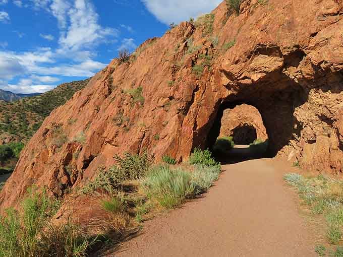 Hand-carved tunnels through red rock remind you that sometimes the best paths require a little creative engineering.