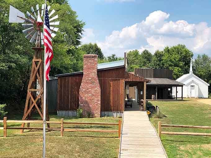 A windmill and brick chimney anchor this collection of frontier buildings, where history meets Kentucky hospitality in unexpected harmony.