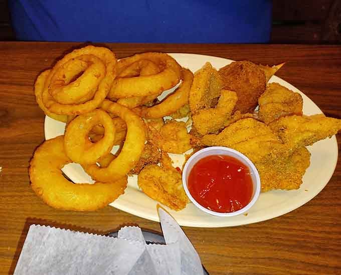 Golden onion rings and perfectly fried catfish on one plate: this is what Southern comfort food dreams are made of.