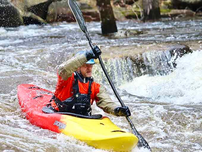 This kayaker navigates whitewater with the focus of someone who knows exactly where the fun lives today.