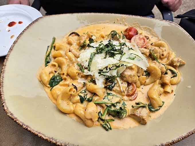 Bowtie pasta with chicken, spinach, and tomatoes in cream sauce &ndash; comfort food that went to finishing school.