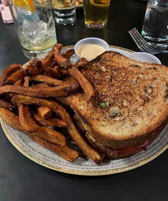 The Big Jim sandwich arrives with fries that could make a grown person weep tears of pure, unadulterated joy.
