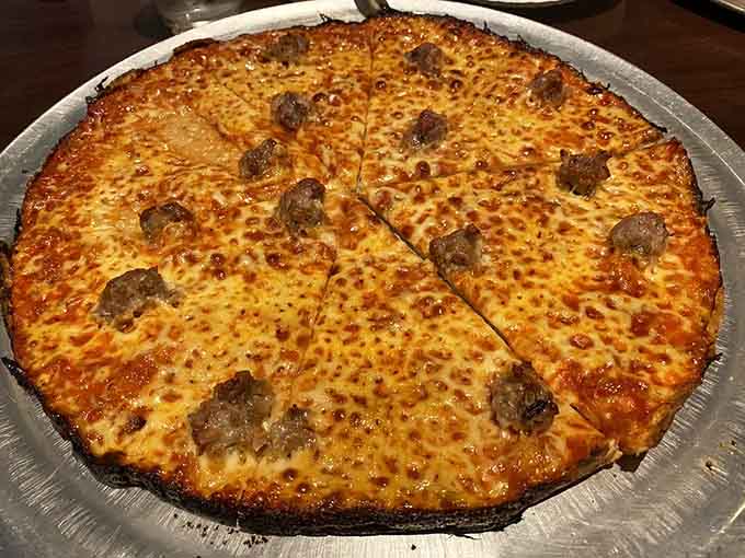 Those perfectly placed sausage rounds on cracker-thin crust prove less dough means more flavor every time.