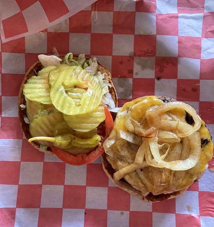 Two magnificent burger specimens topped with rings of grilled onions that could make a grown person weep with joy.