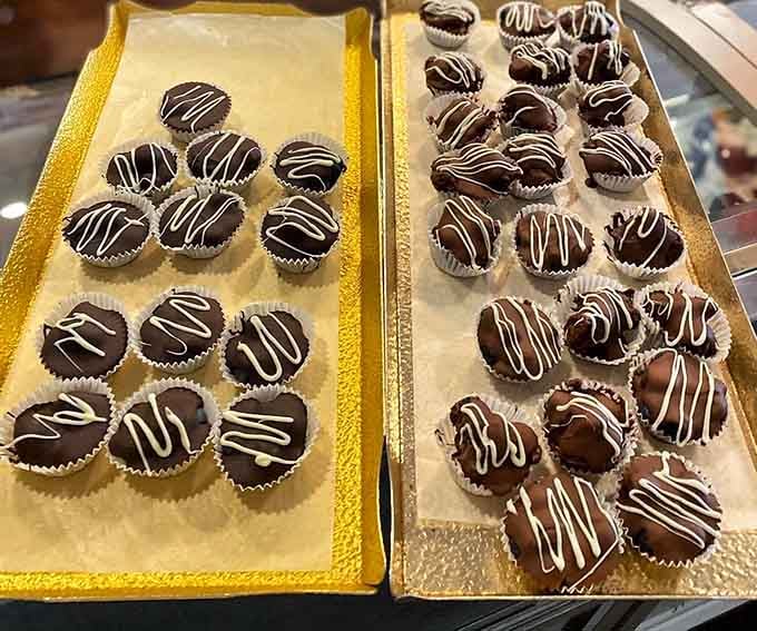 Dark and milk chocolate blueberry cups sitting side by side, proving chocolate doesn't discriminate, it just delights.
