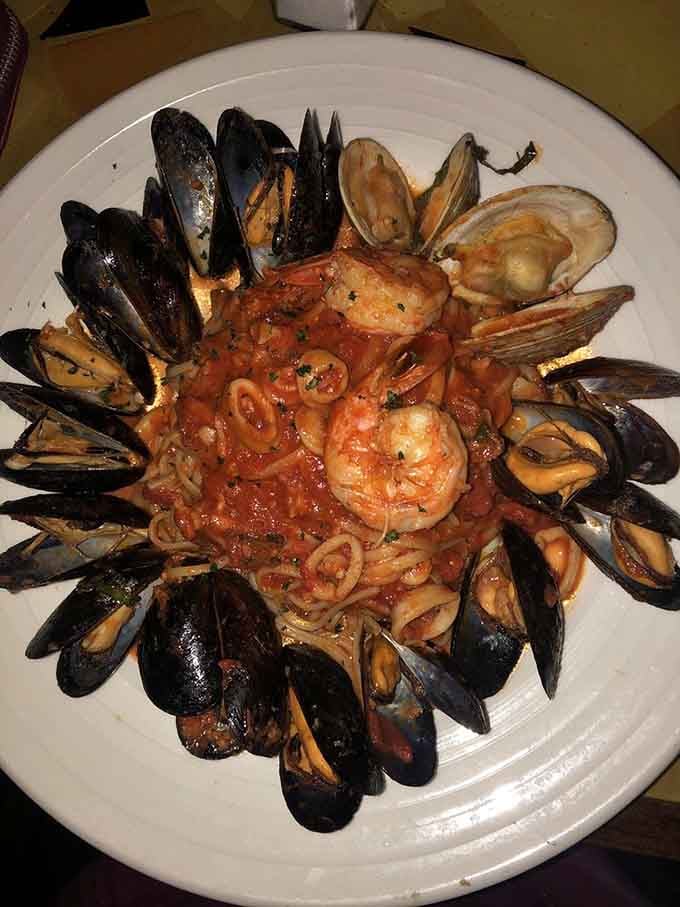 Mussels and clams arranged like a crown around pasta—this is seafood royalty on a plate, folks.