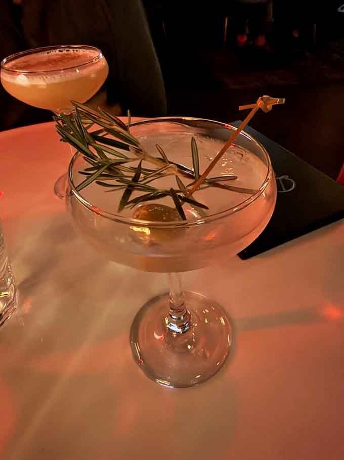 That rosemary sprig isn't just garnish, it's a fragrant promise that this cocktail means business in the best way.
