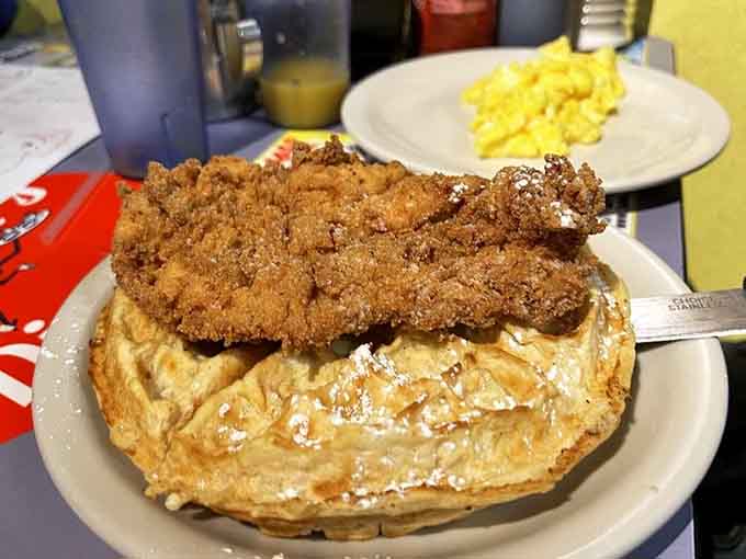 Chicken and waffles topped with enough fried goodness to make your cardiologist schedule an intervention meeting.