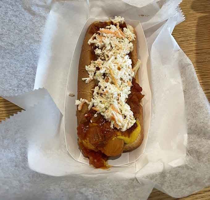 That hot dog topped with coleslaw proves sometimes the simplest combinations create the most memorable flavor symphonies in your mouth.