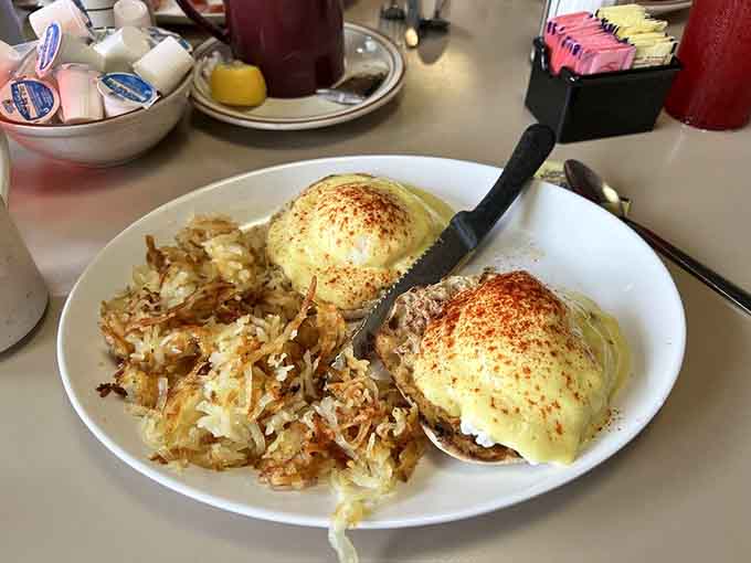 Two perfectly poached eggs draped in hollandaise over crispy hash browns, because some mornings demand elegance with substance.
