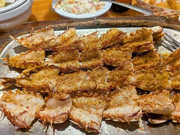 Butterflied rock shrimp looking like tiny lobster tails, because sometimes the best things really do come in small, golden-fried packages.