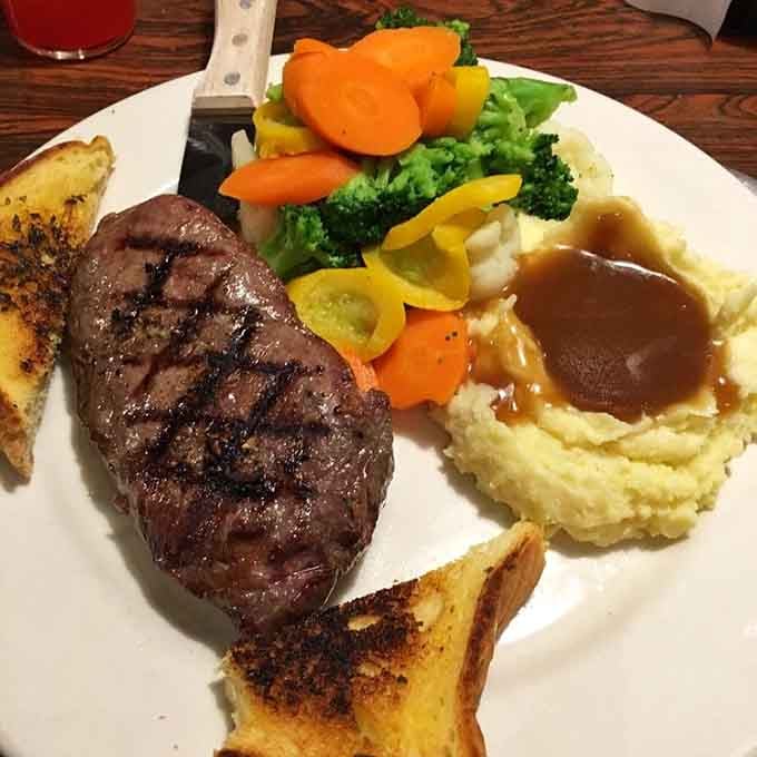 This perfectly grilled steak comes with all the fixings, proving that cowboys knew what they were doing when it came to a proper meal after a long day on the range.