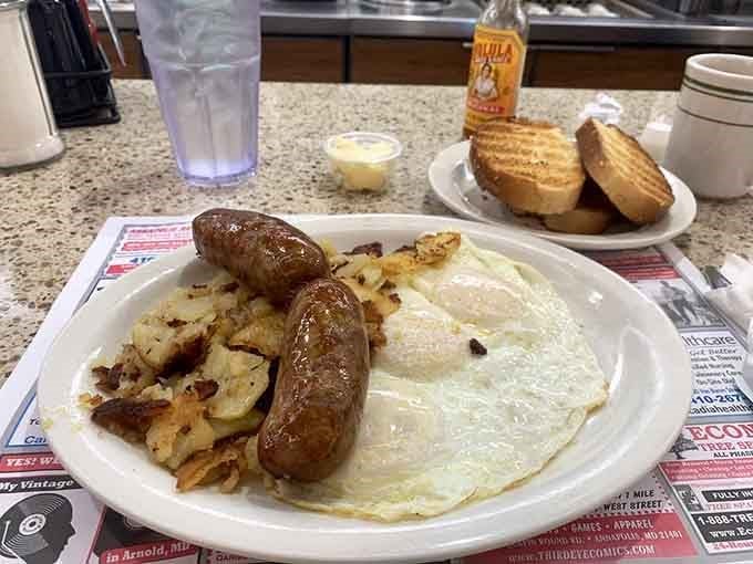 Eggs, sausage, hash browns, and toast form a breakfast dream team that would make any morning person weep with joy.