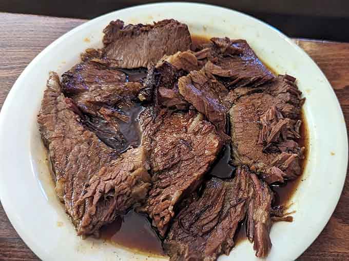Behold the brisket in all its smoky glory, tender enough to make Texans reconsider their state pride.