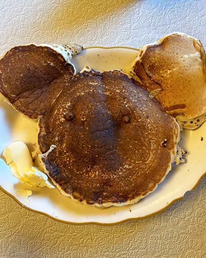 Golden pancakes swimming in syrup prove that some breakfast traditions never go out of style, no matter the decade.