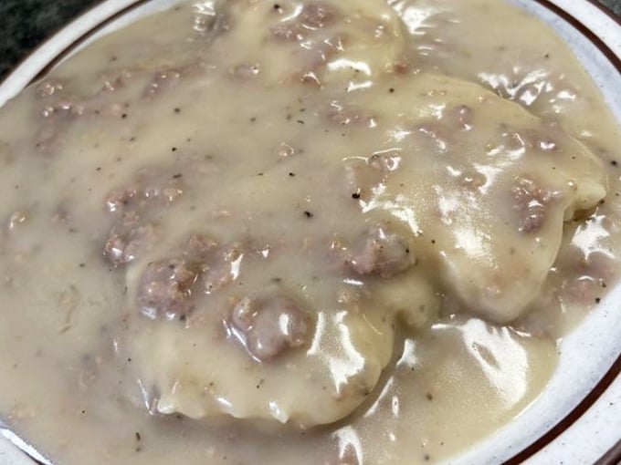 Biscuits and gravy that look like they could solve most of life's problems, one creamy, peppery bite at a time.