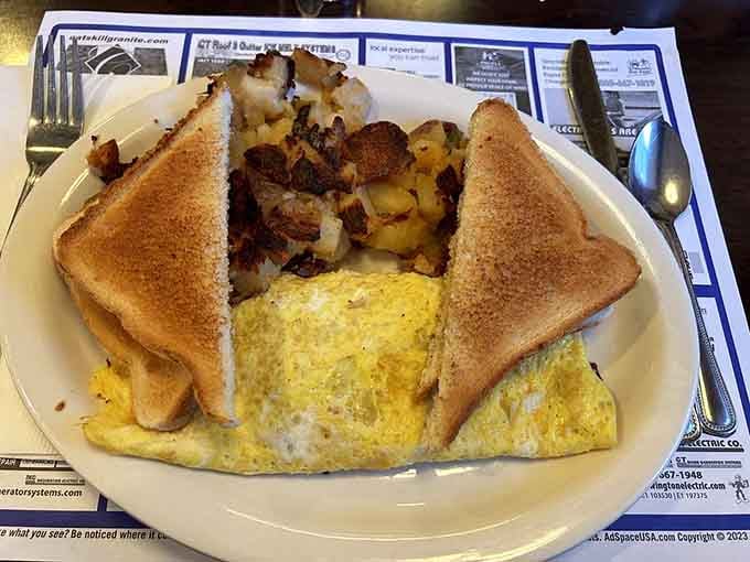 That Philly Steak Omelet arrives like a fluffy pillow stuffed with savory dreams and zero regrets about carb consumption.