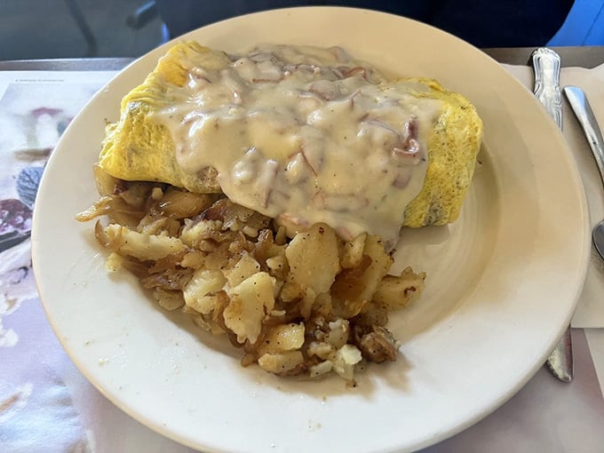 The Lumberjack Omelette arrives smothered in creamy mushroom gravy, ready to fuel your entire day ahead.