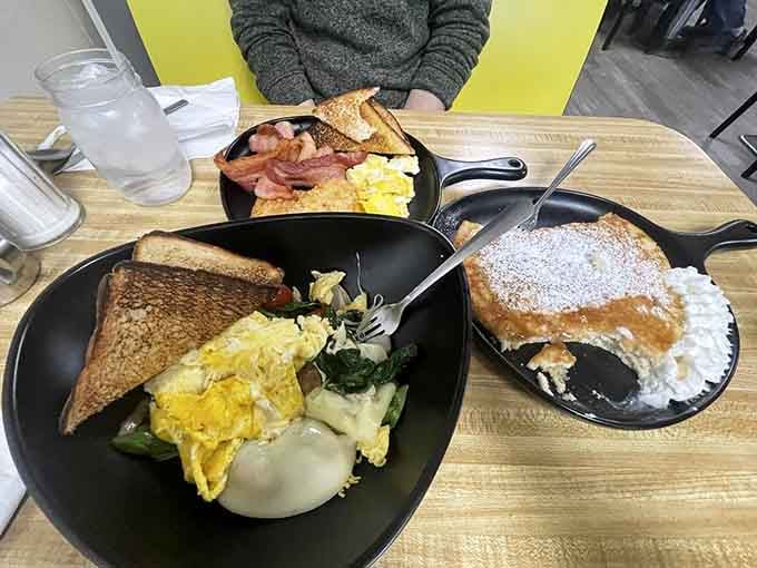 The Farmer's Breakfast doesn't mess around with portions, delivering eggs, bacon, biscuit, and satisfaction on one glorious plate.