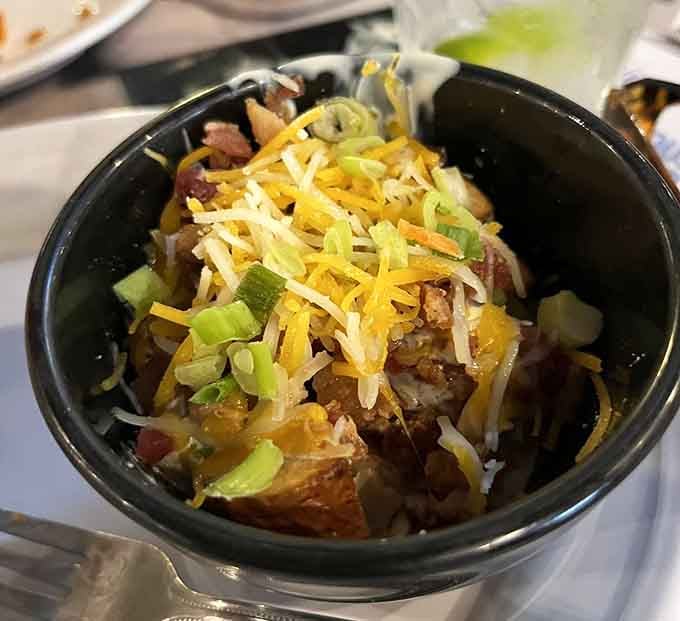 Loaded red potatoes topped with enough cheese and green onions to make you reconsider your side order.