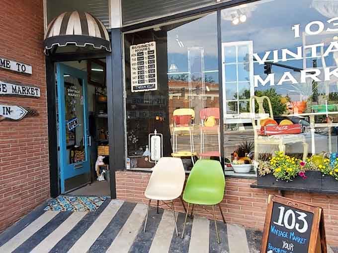 Mid-century modern chairs beckon from the sidewalk, proving that good design never goes out of style, just gets more expensive.