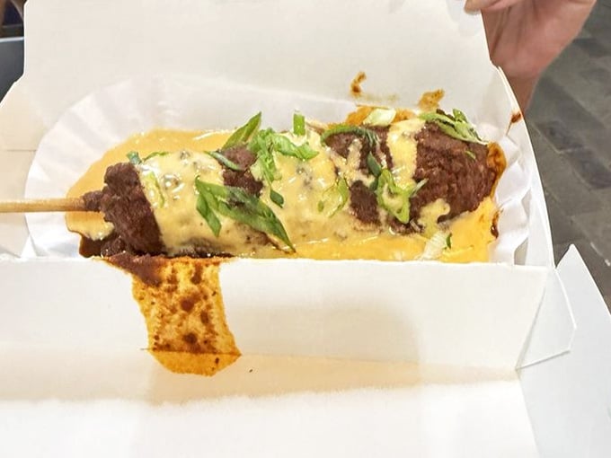 Chili cheese scallion corn dog drizzled with golden sauce, because sometimes restraint is overrated and flavor is everything.