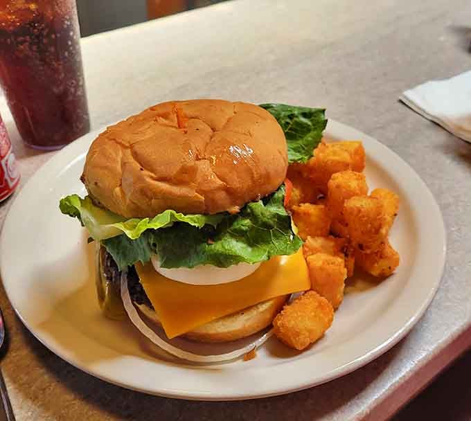 This burger with its golden cheese and crispy tots proves that lunch at a breakfast joint can be just as spectacular.