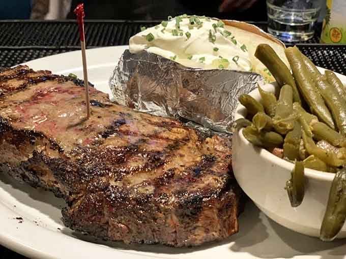 That ribeye comes with a loaded baked potato and green beans, proving vegetables can hang with greatness.