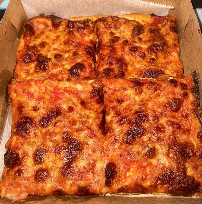 Golden, bubbly perfection in a box: Sicilian pizza that'll make you forget every other slice you've ever had.