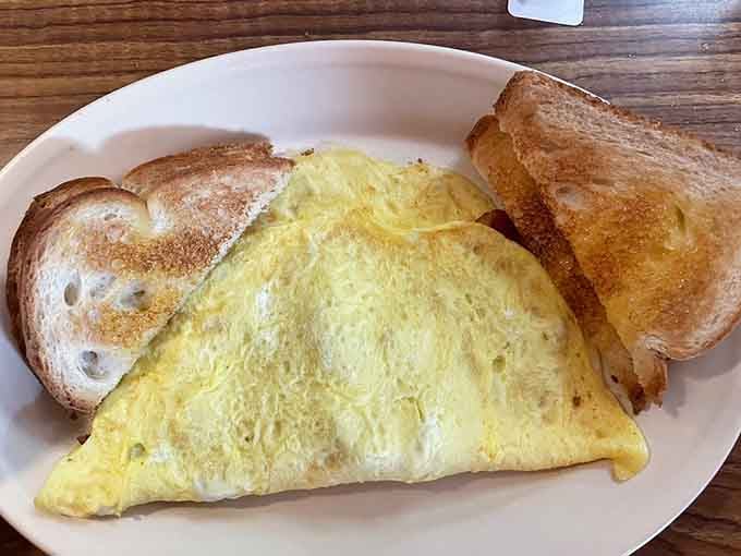 A perfectly folded omelet with golden toast proves that breakfast doesn't need to be complicated to be completely satisfying.