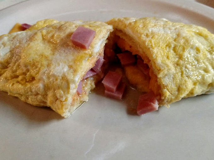Fluffy eggs folded around chunks of ham and melted cheese, this is what omelet dreams are made of.