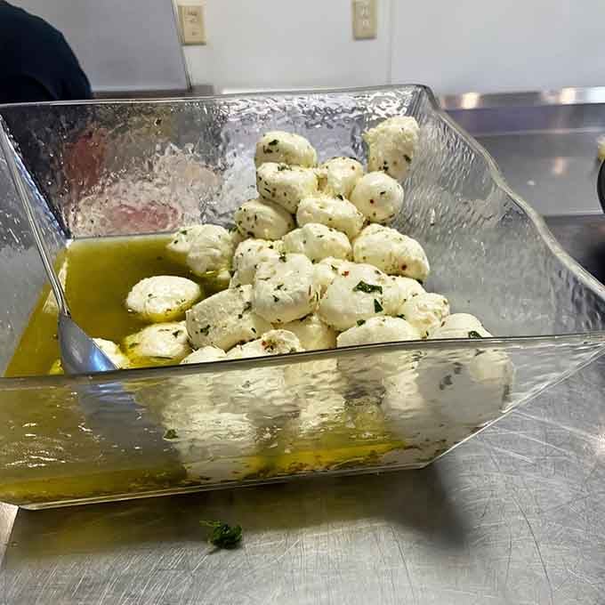 Fresh mozzarella swimming in olive oil and herbs. This is what cheese dreams about becoming when it grows up.