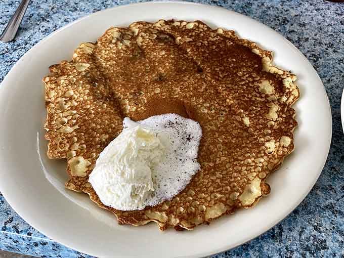Golden perfection on a plate, topped with butter that melts into pure morning bliss with every forkful.