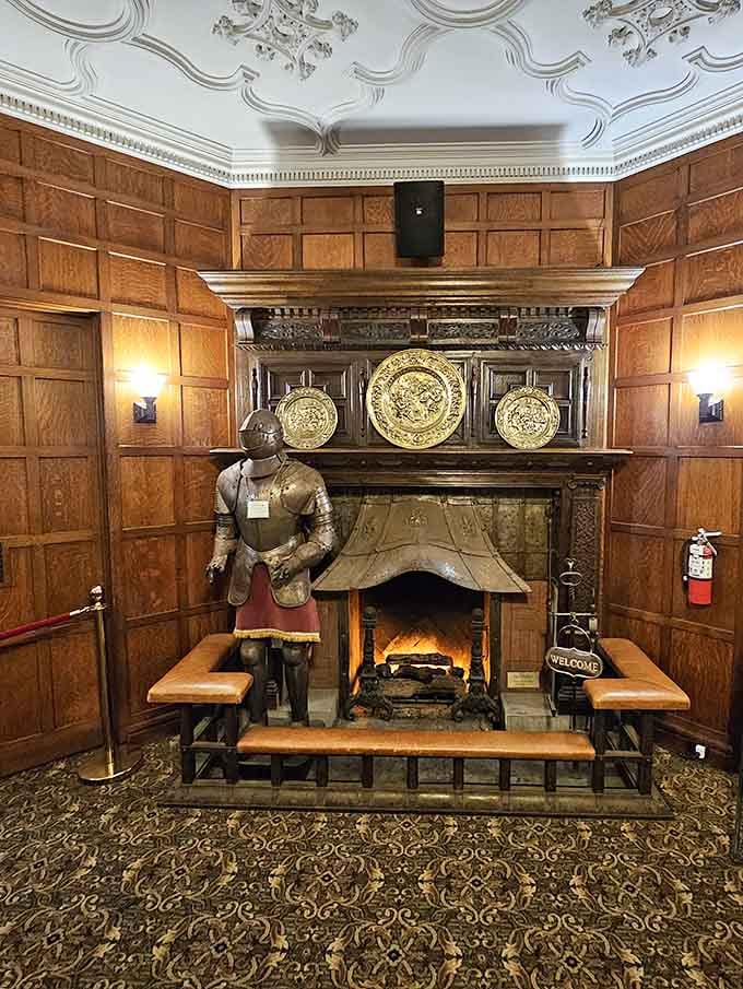 A suit of armor standing guard by the fireplace, because every proper castle needs a little medieval flair.