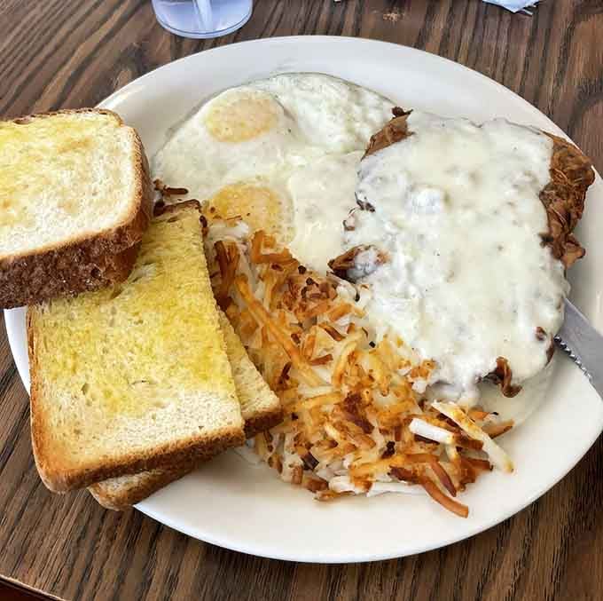 Chicken fried steak smothered in gravy with eggs and hash browns: breakfast doesn't get more gloriously American than this.